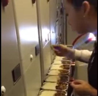 Flight Attendant Videotaped Eating Passenger Meals - View from the Wing
